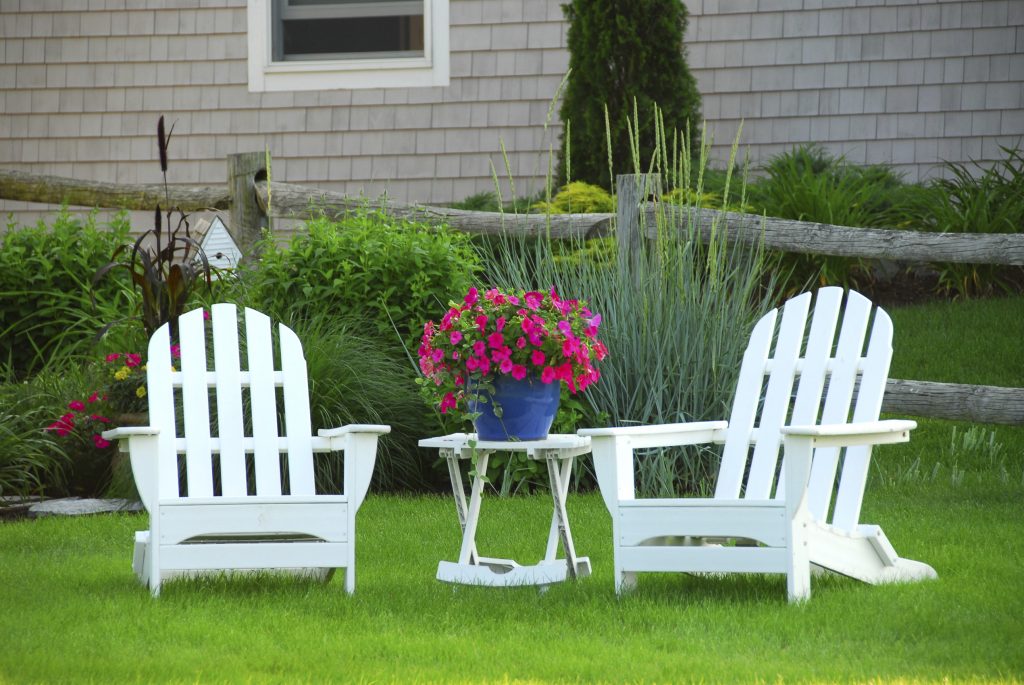 Two lawn chairs in a beautifl garden near cottage - Farmer's Weekly